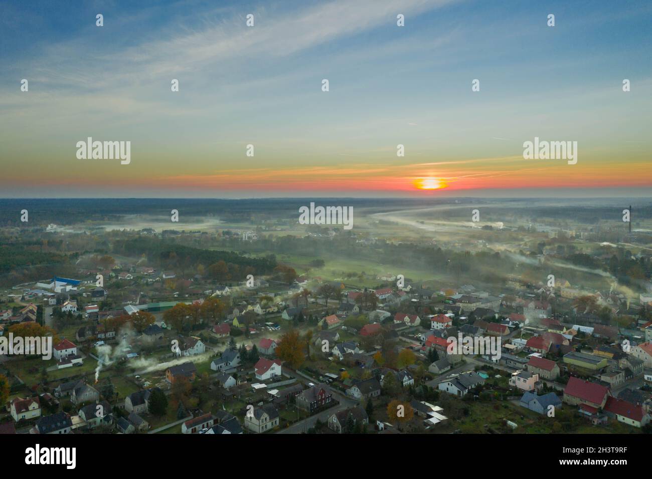 A small provincial town. A plume of smoke hangs over the buildings ...