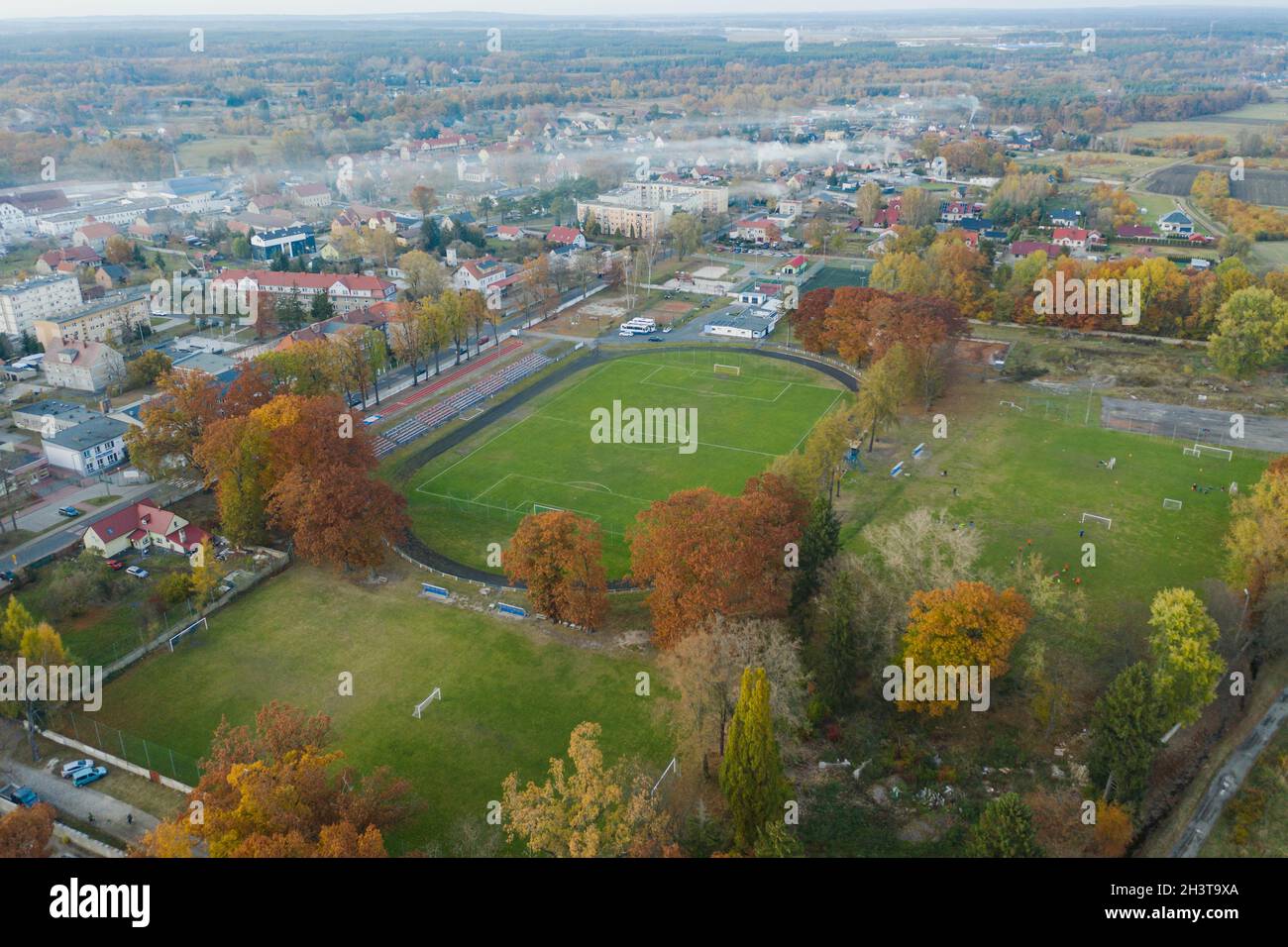Soccer stadium in a small village. Green turf, a small stand for fans ...