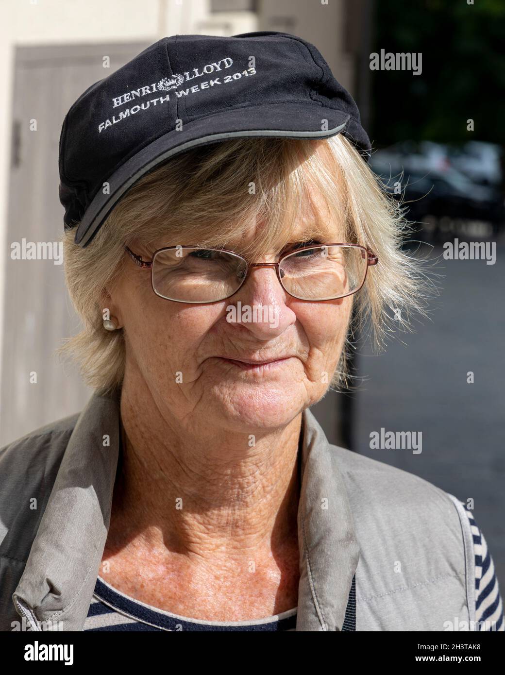 75 year old woman pinches the photographer's cap! Stock Photo - Alamy