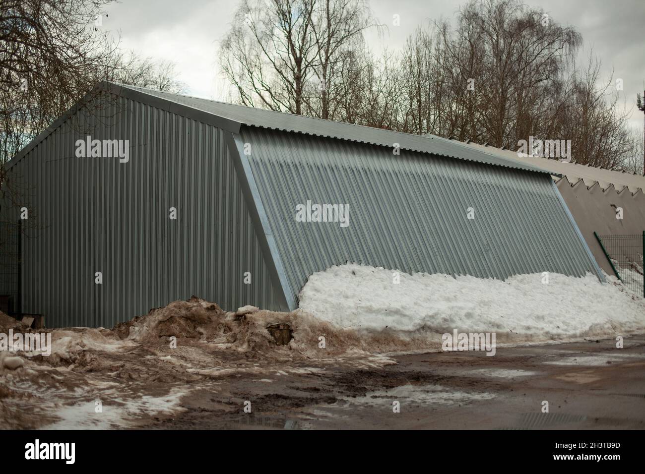 Metal warehouse outside. Storage room for municipal equipment. Snow ...