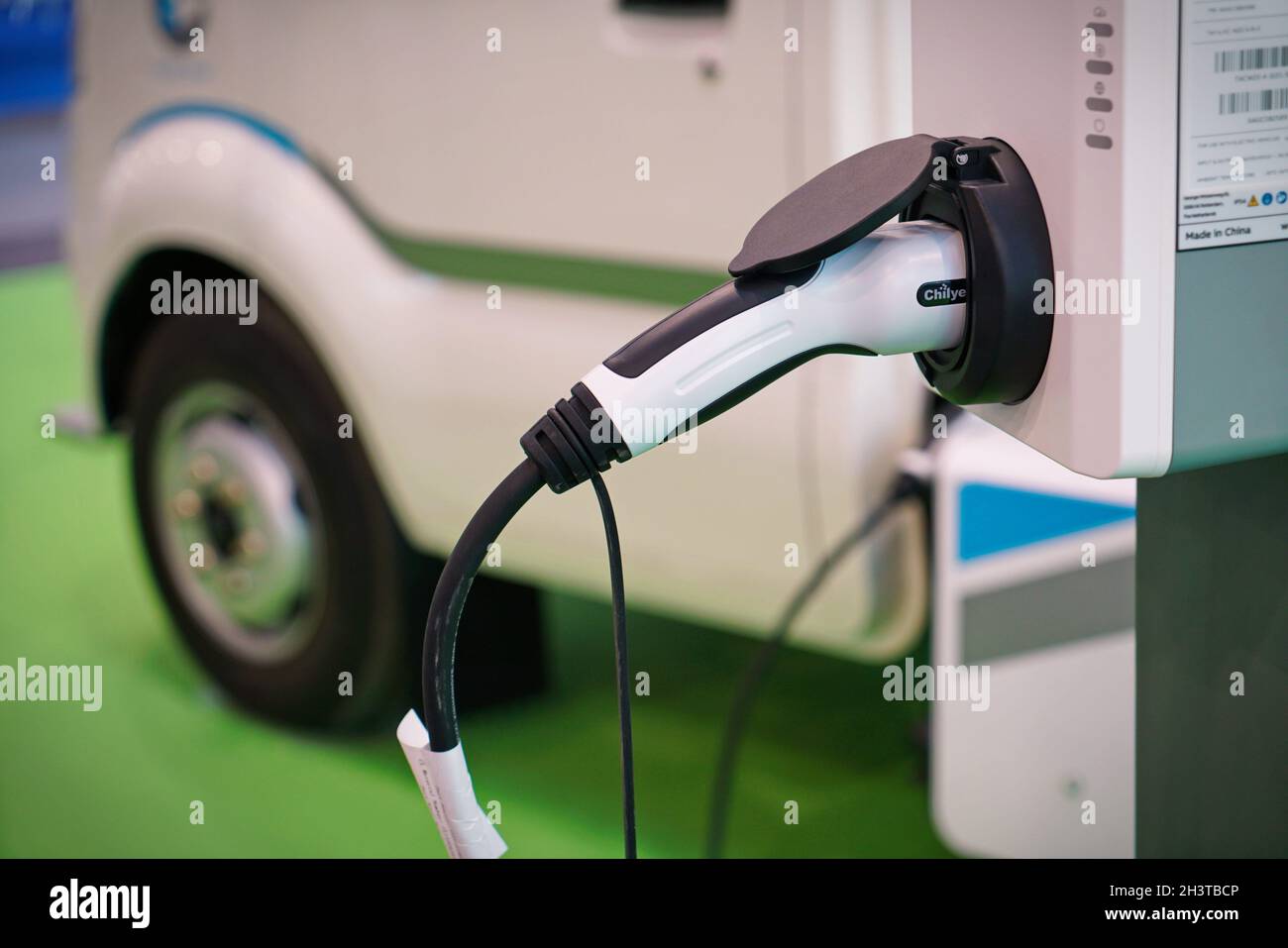 Power cable pump plug in charging power to electric vehicle EV car with ...