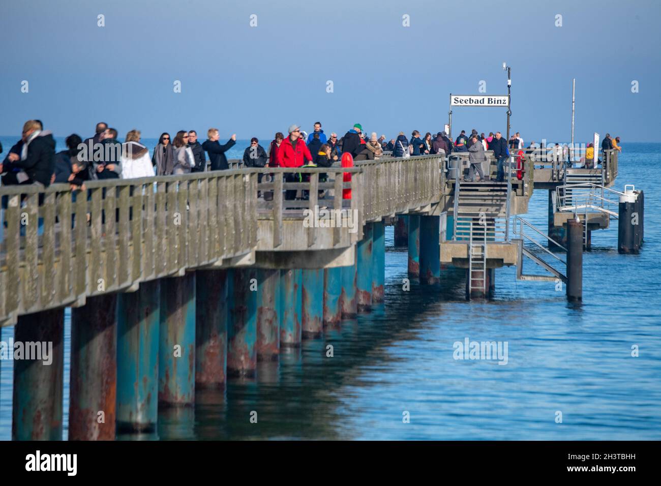 Binz, Germany. 30th Oct, 2021. Tourists walk on the beach on the pier ...