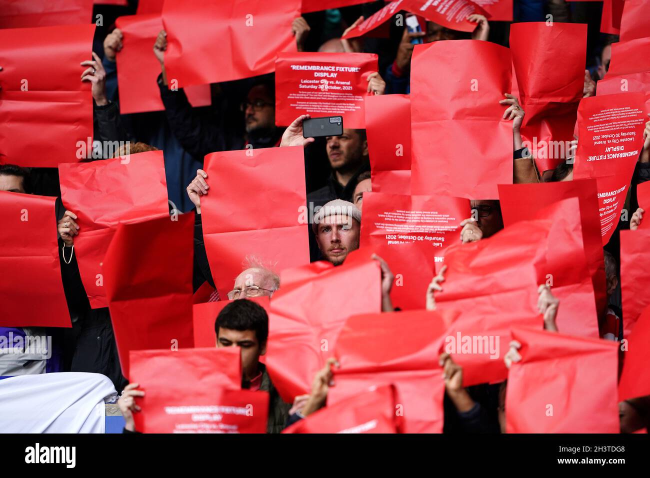 Arsenal fans hold cards in the form of a poppy during a minute's ...