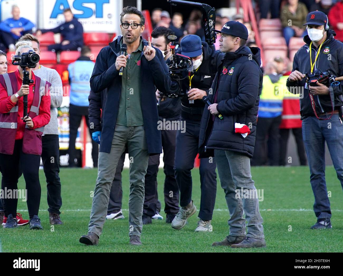Wrexham owners Ryan Reynolds (left) and Rob McElhenney speak to the ...