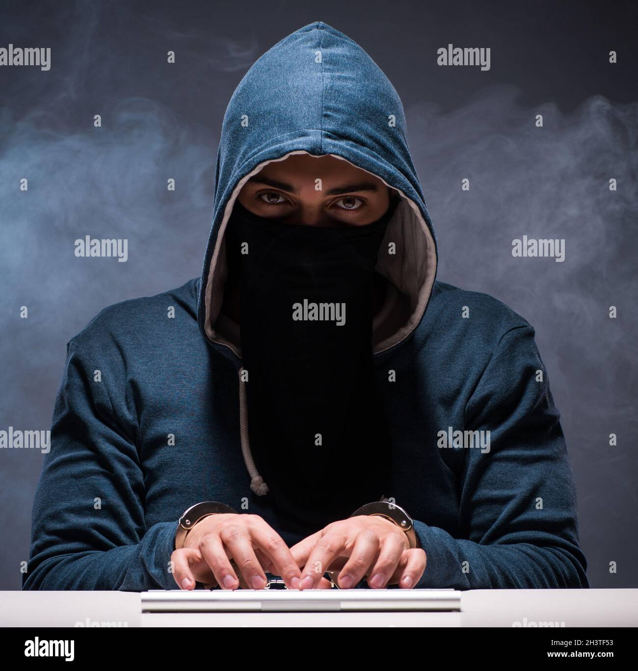 Computer hacker working in dark room Stock Photo - Alamy