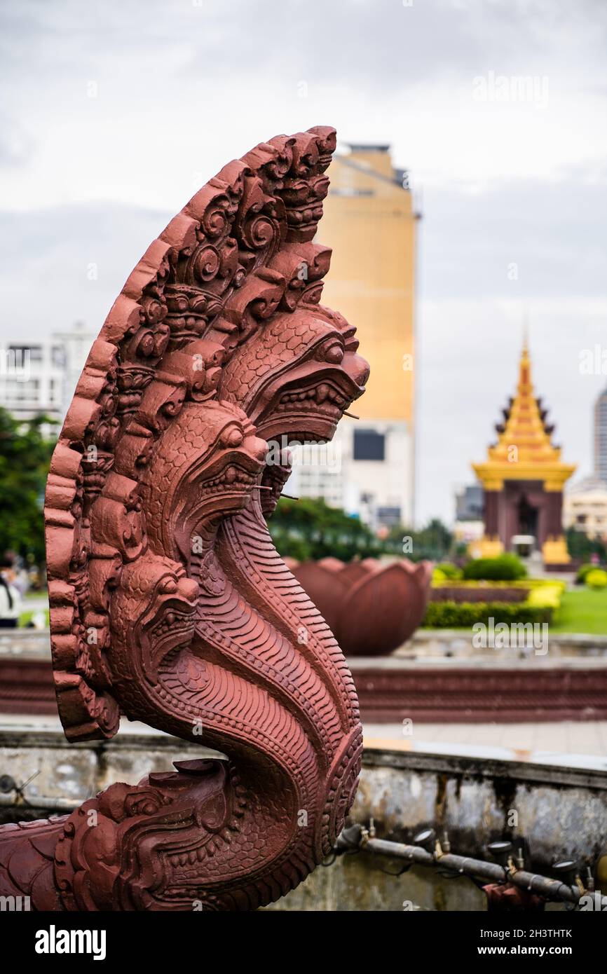 Close up shot of red fountain statue of snake with three heads in a ...