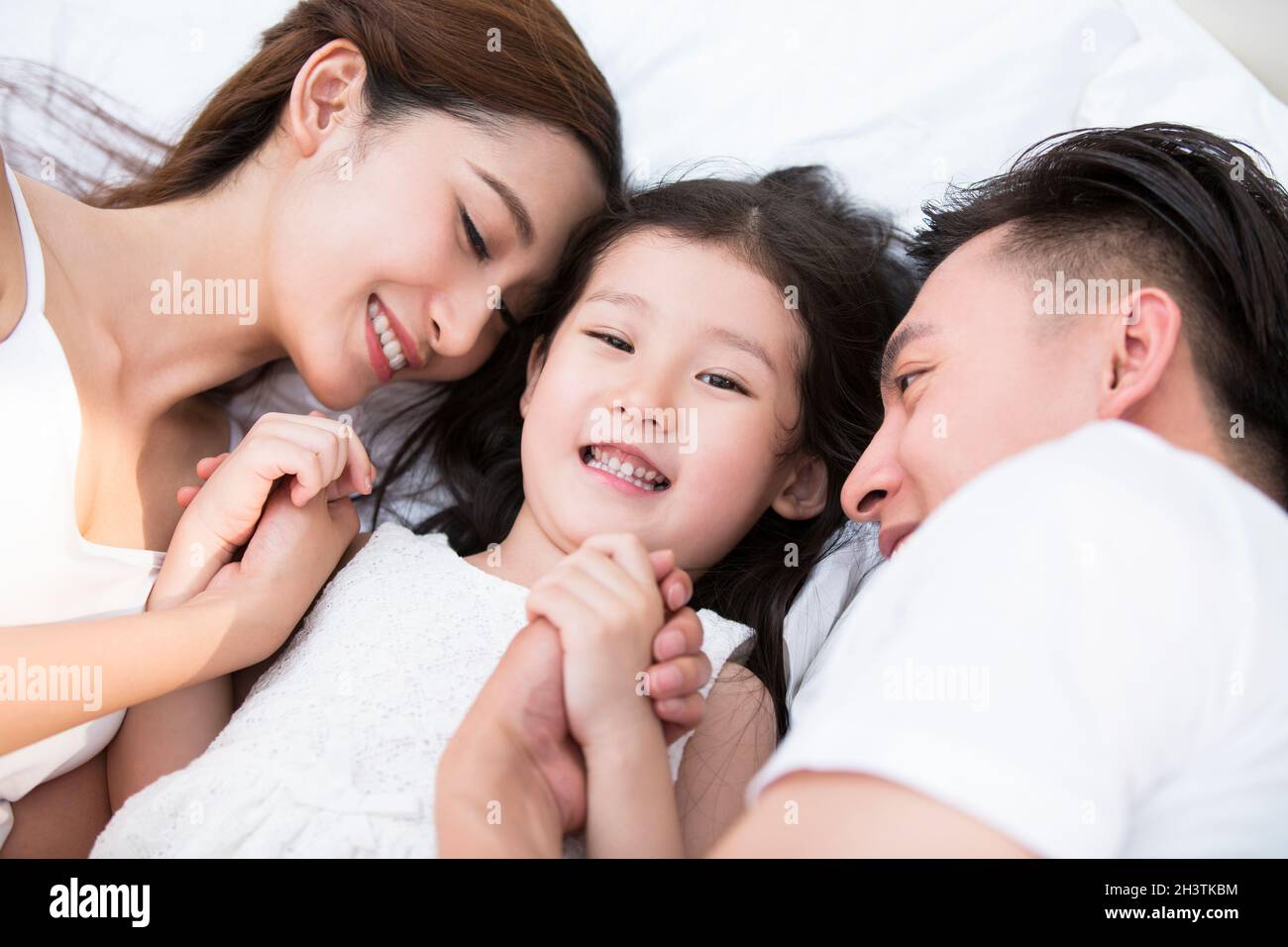 Warm and loving family of three Stock Photo - Alamy