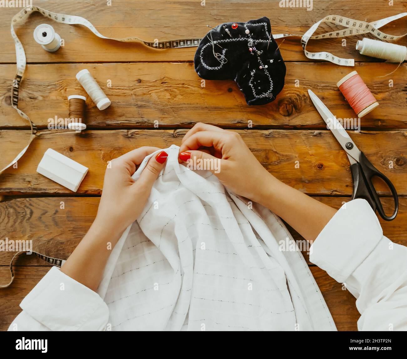 Female dressmaker creating clothes in workshop Stock Photo - Alamy