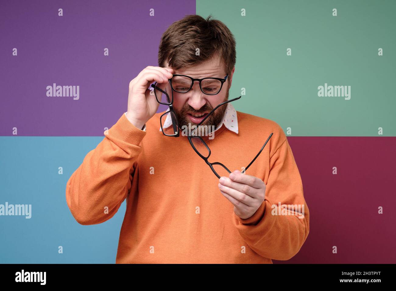 Man with a strange expression on face in a stupor, he selects and ...