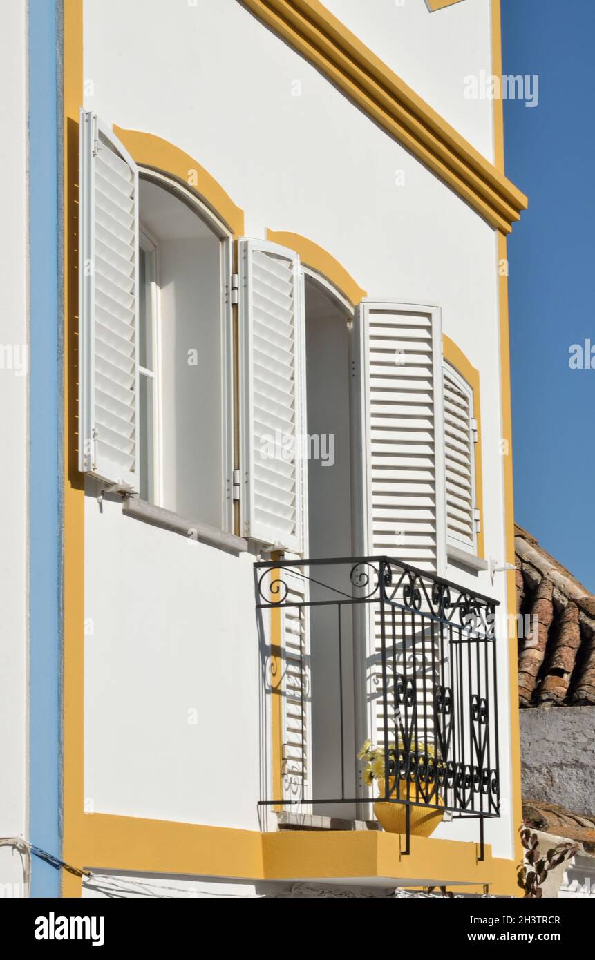 Traditional facade with window and balcony in the Algarve - Portugal ...
