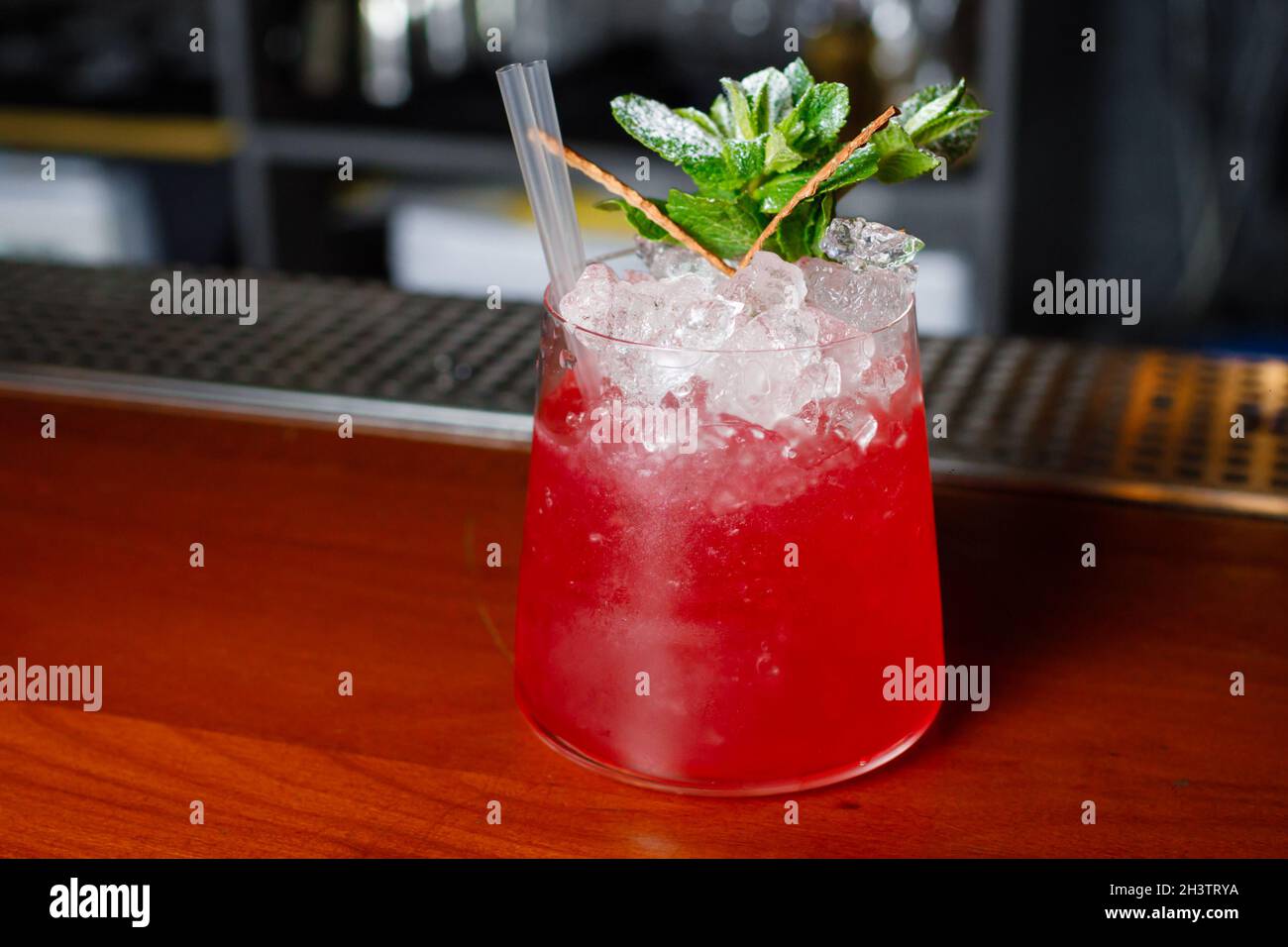 Red alcoholic cocktail on a bar counter in a bar Stock Photo - Alamy