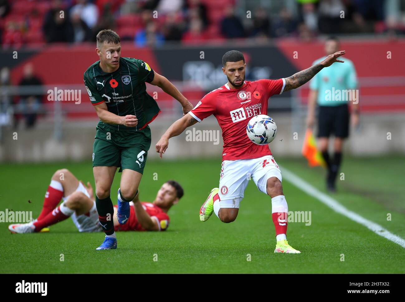 Barnsley's Mads Juel Andersen (left) and Bristol City's Nahki Wells ...