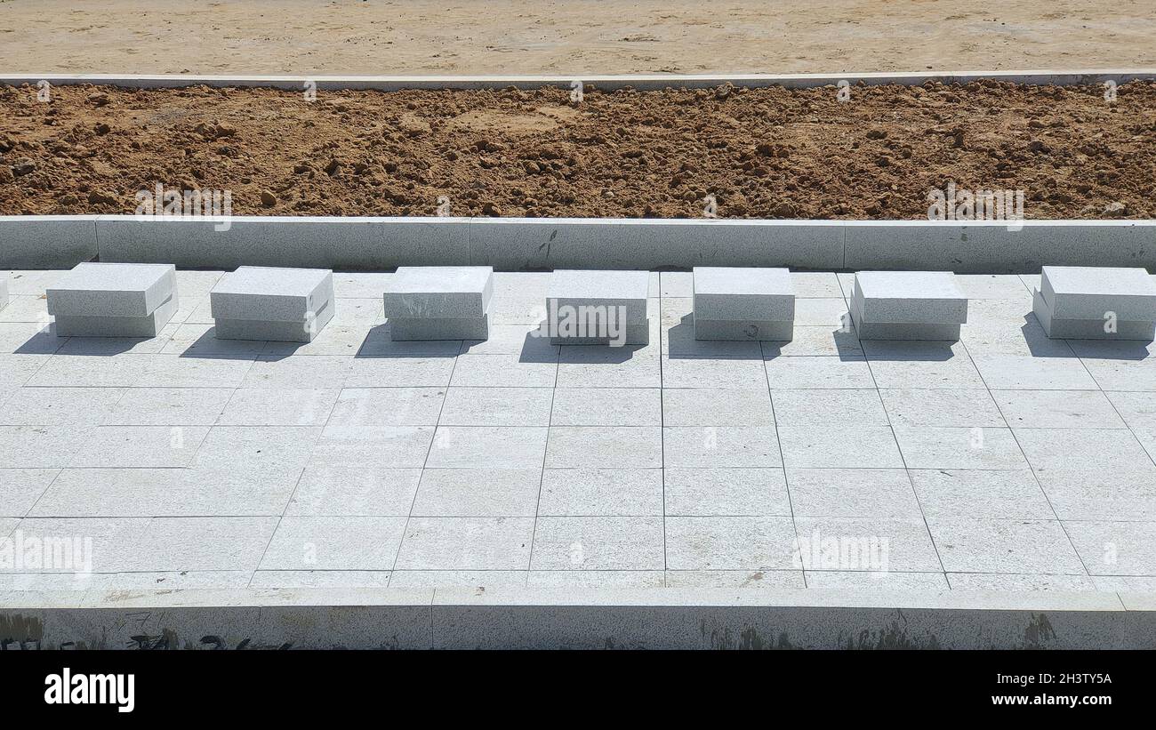 Installation of paving slabs tile on a city street Stock Photo - Alamy