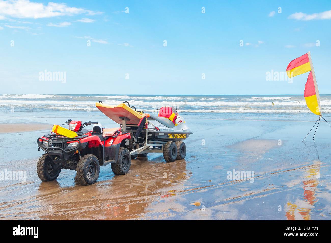 RNLI lifeguard ATV with rescue power boat jet ski on trailer on beach ...