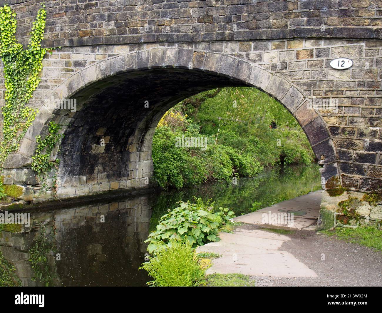 An old stone bridge crossing the rochdale canal at mytholmroyd west ...