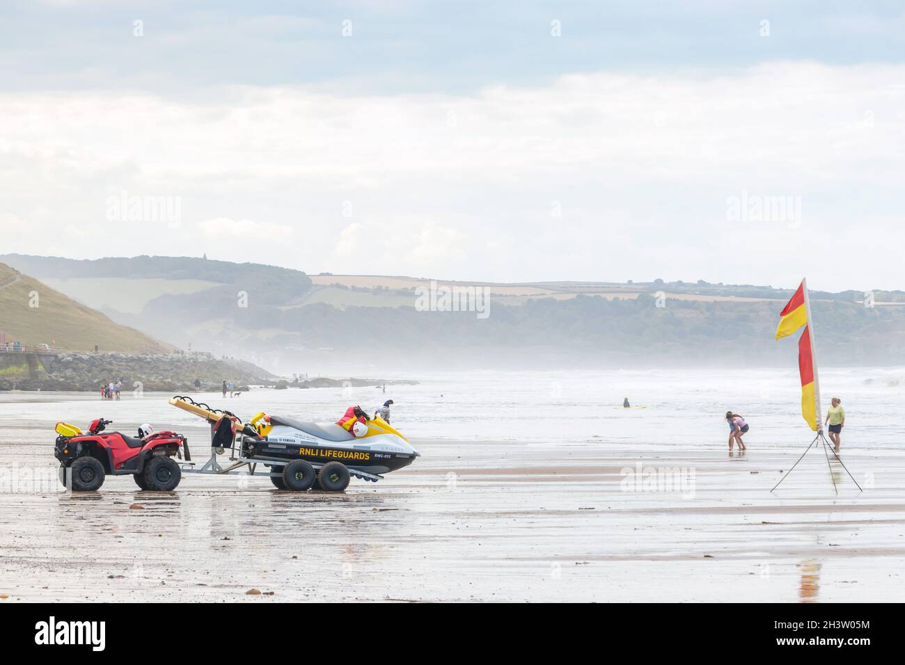 RNLI lifeguard ATV with rescue power boat on trailer on beach at Whitby ...