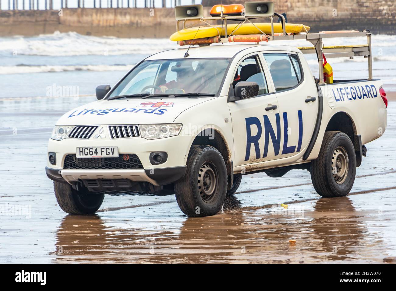 RLNI lifeguard Mitsubishi rescue pick up truck on beach at Whitby Stock ...