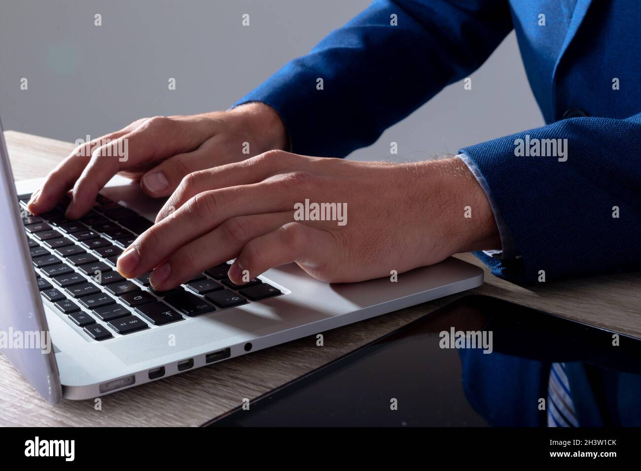Midsection of caucasian businessman typing on keyboard, isolated on ...