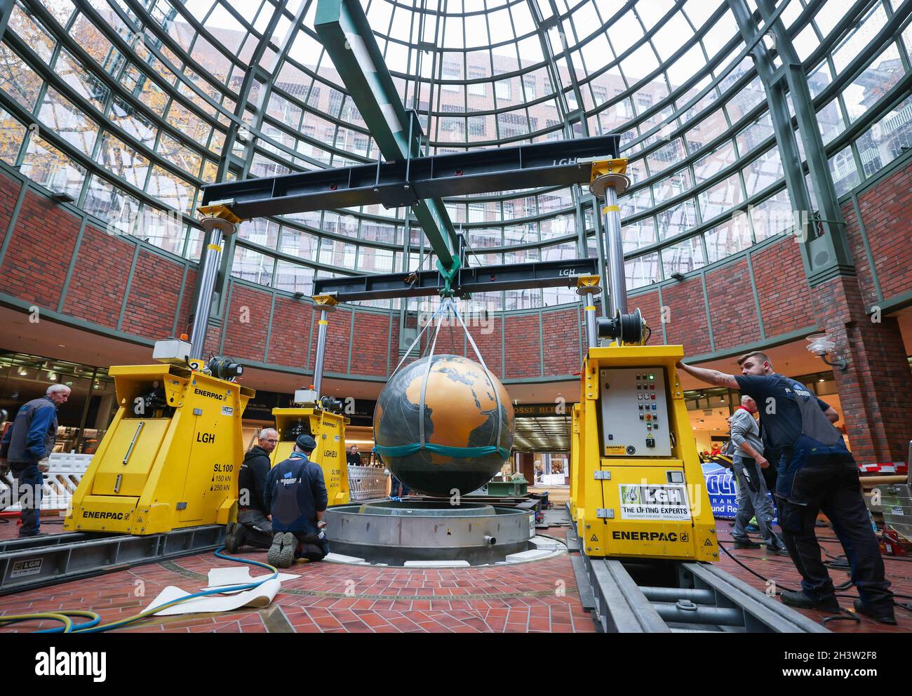 Hamburg, Germany. 30th Oct, 2021. Experts use a hoist crane to lift the ...