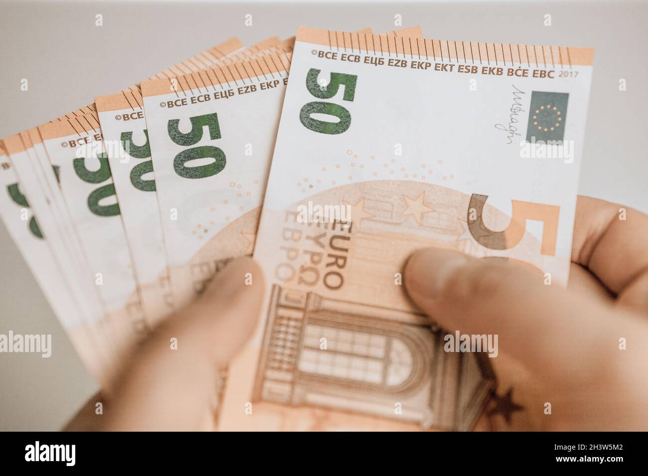 Hand euro on grey hi-res stock photography and images - Alamy