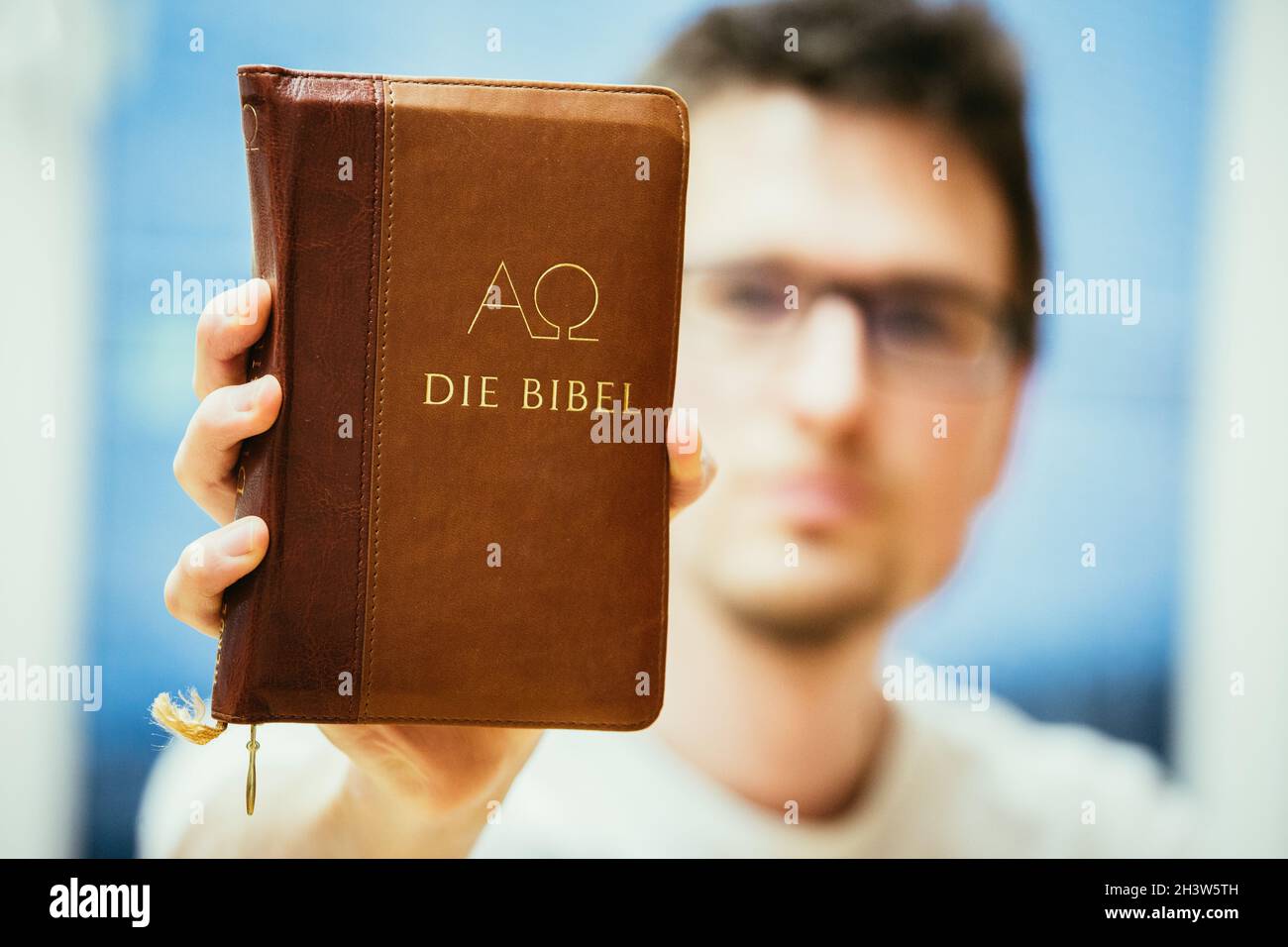 Christian preacher: Young man is holding the bible, praying Stock Photo ...