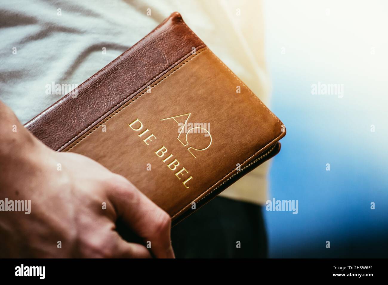 Christian preacher: Young man is holding the bible, praying Stock Photo ...