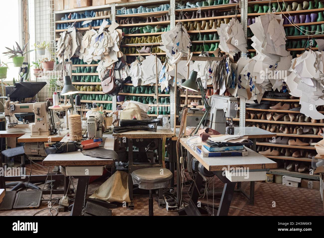 Image of workshop with tables with sewing machines on them shoe models ...