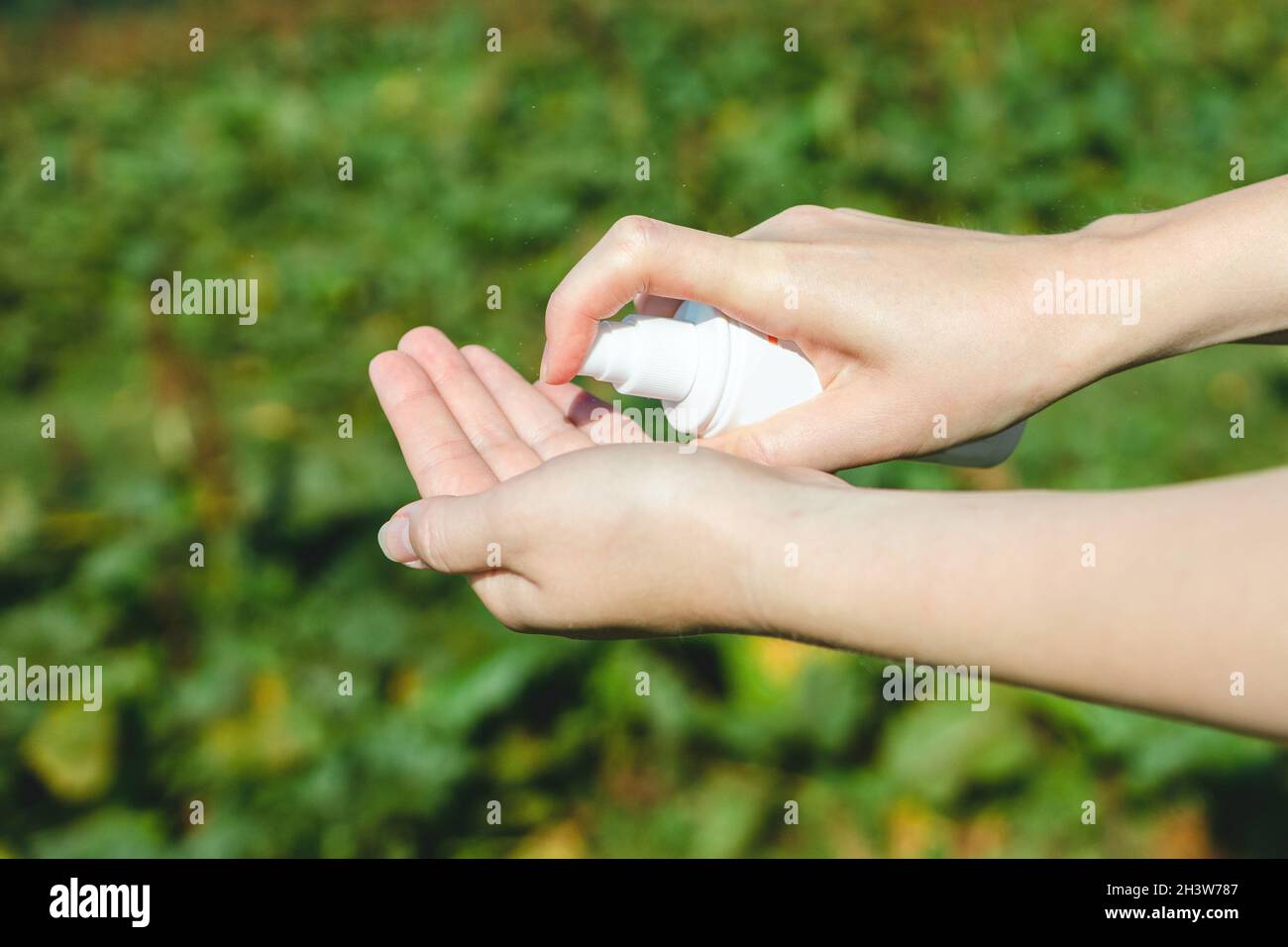 Girl holding sunscreen bottle. Woman protecting skin with sunblock ...