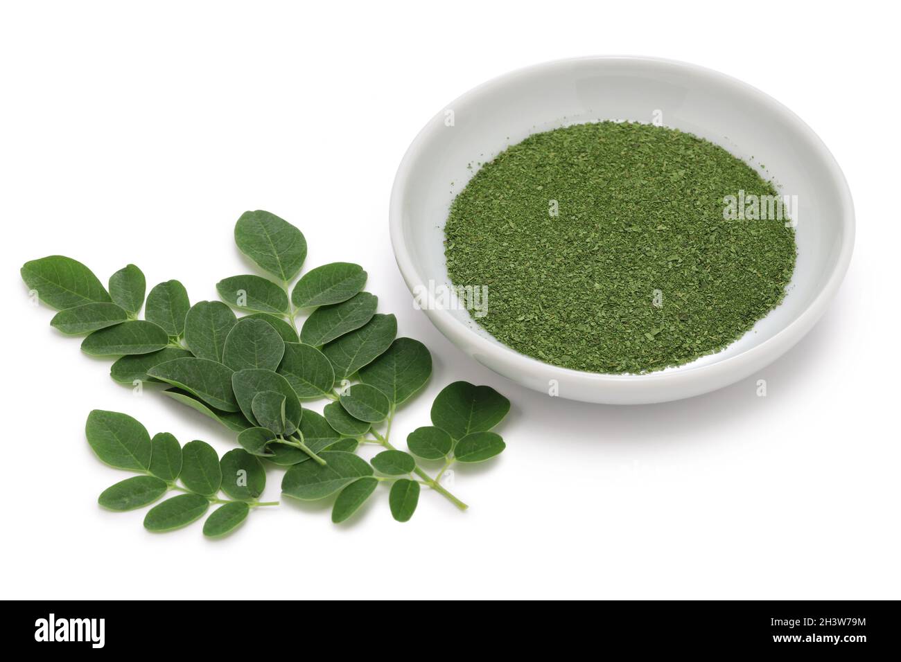 moringa leaves and powder on white background Stock Photo - Alamy