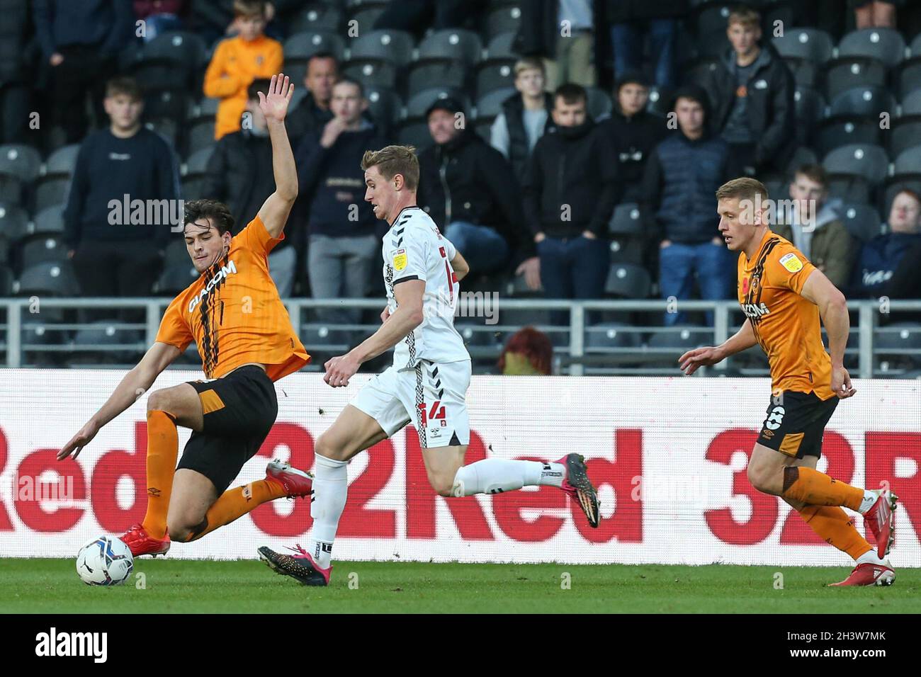 Jacob Greaves #4 of Hull City dives in to tackle Ben Sheaf #14 of ...