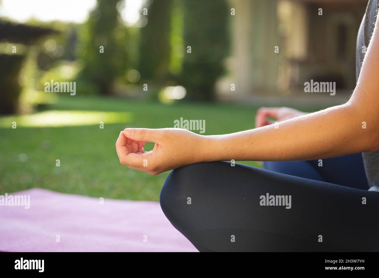 Midsection young woman meditating hi-res stock photography and images ...