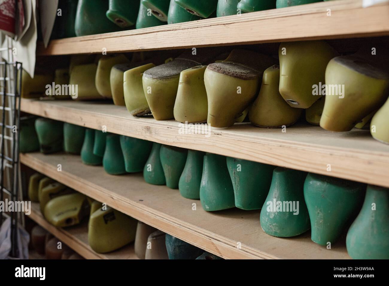 Close-up of wooden last on the shelves for creation of new shoes in the ...