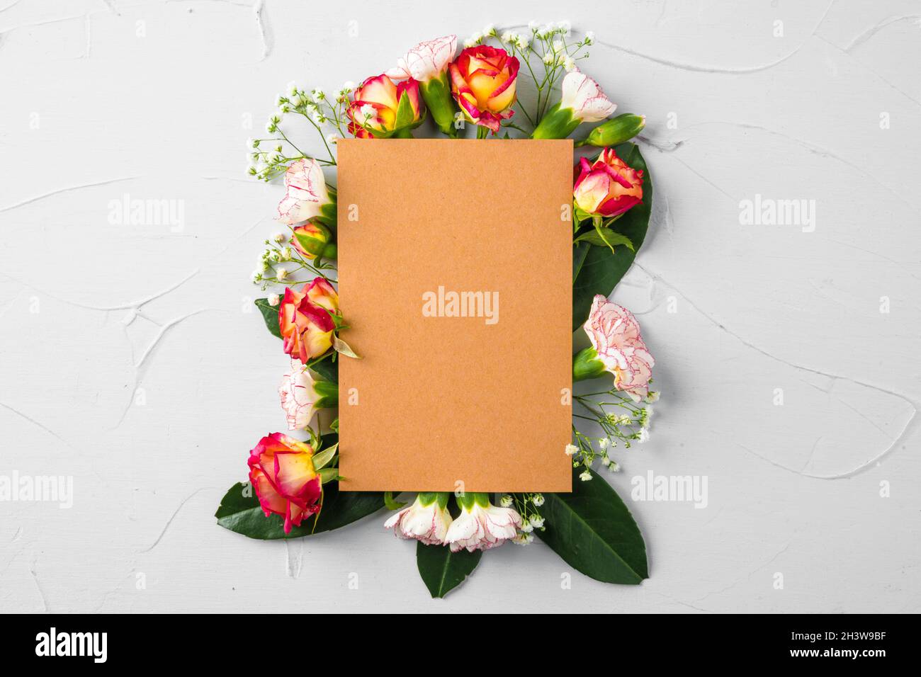 Blank notepad page with flower branch, top view Stock Photo - Alamy