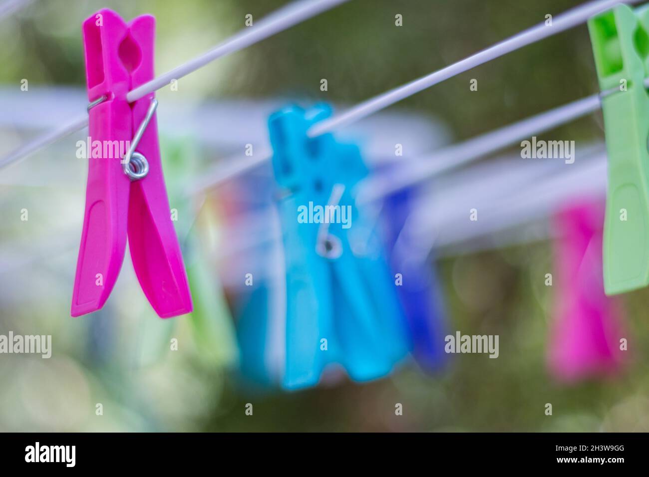 Colorful clothe pegs on a clothes line Stock Photo - Alamy