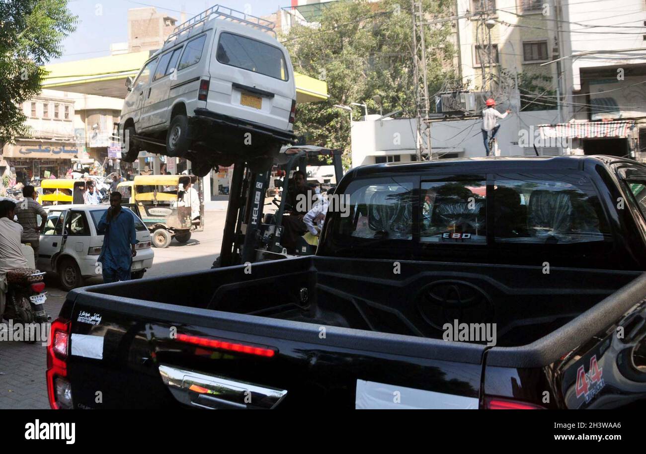 Traffic police car lifter lifts car that parked in no parking area ...