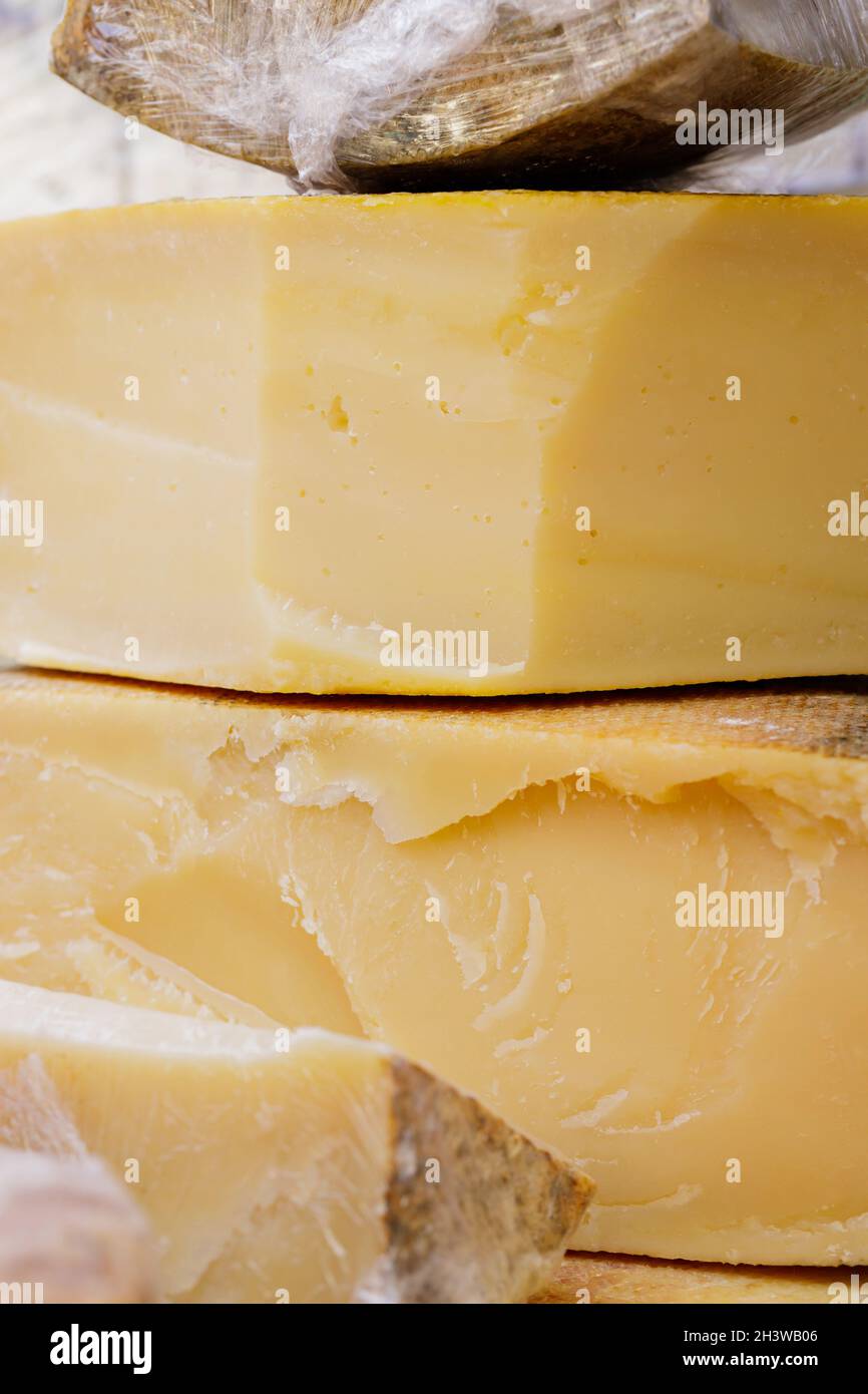 Hard goat cheese on the table. Many varieties of craft cheese are on ...