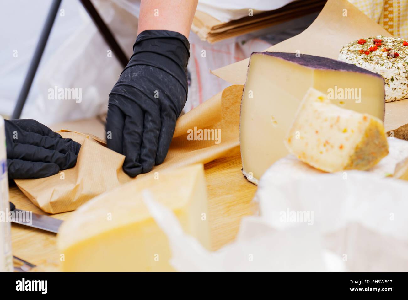 Hard goat cheese on the table. Many varieties of craft cheese are on ...