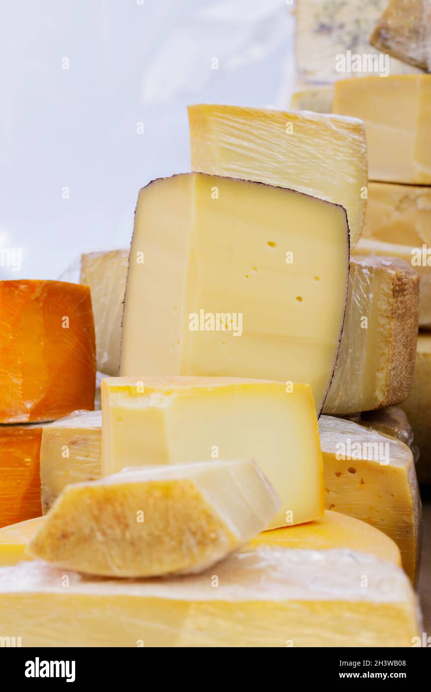 Hard goat cheese on the table. Many varieties of craft cheese are on ...