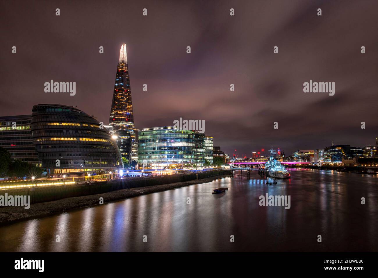 Night time long exposure cityscape looking out onto the River Thames ...