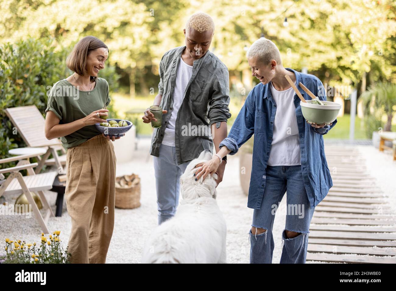 Friends enjoying time together at home backyard Stock Photo - Alamy