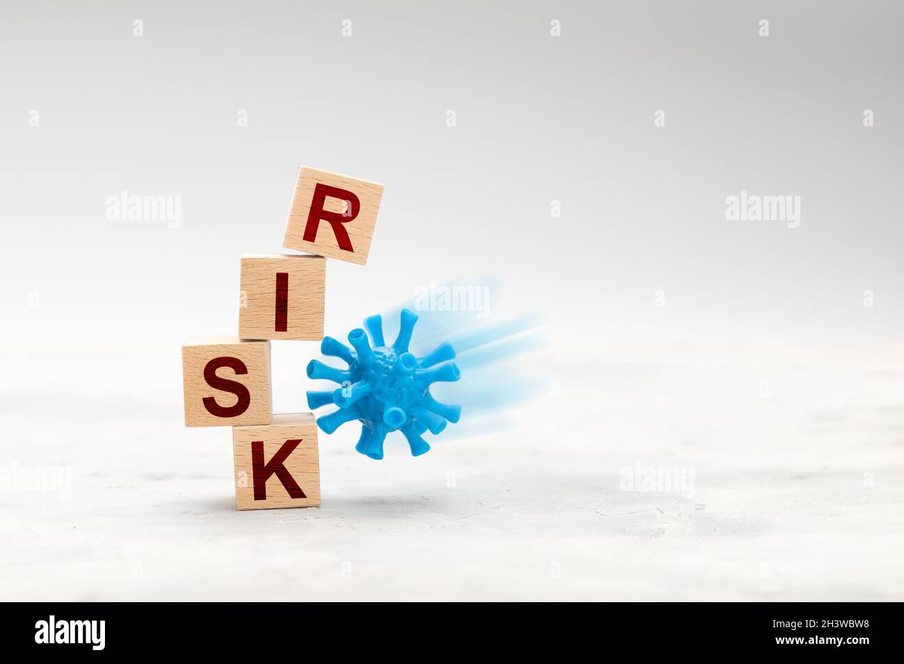 Coronavirus risk. Cubes labeled RISK and blue virus Stock Photo - Alamy