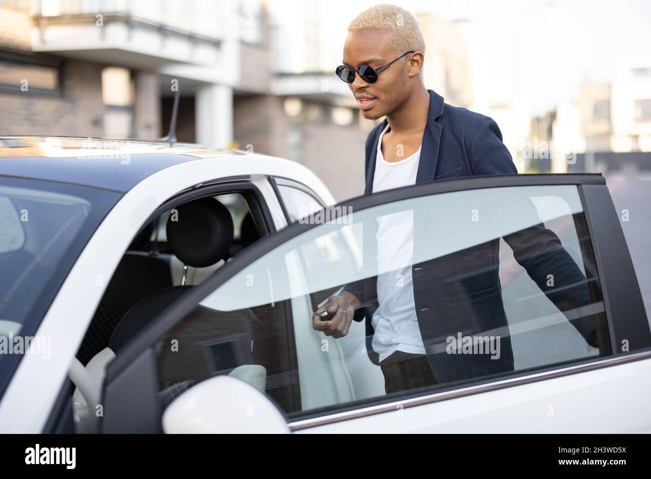 Businessman opening his car Stock Photo - Alamy