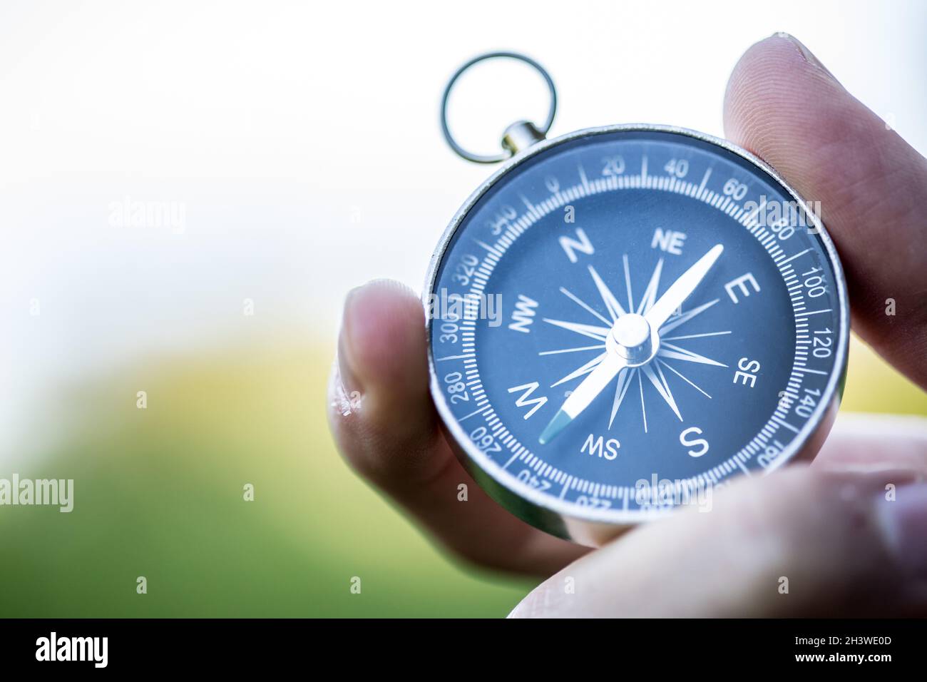 Compass holding in the hand, outdoor adventure Stock Photo - Alamy