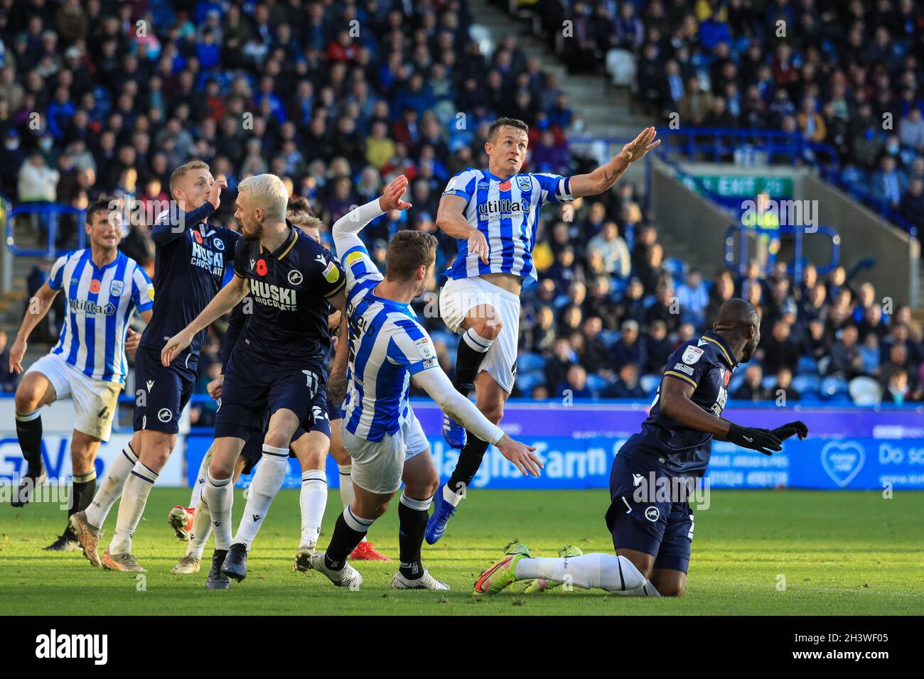 Harry Toffolo #3 of Huddersfield Town goes down as Jonathan Hogg #6 of ...