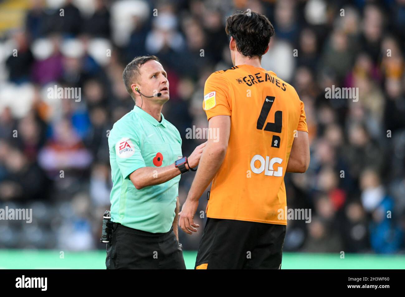 Referee David Webb checks on Jacob Greaves #4 of Hull City after a head ...