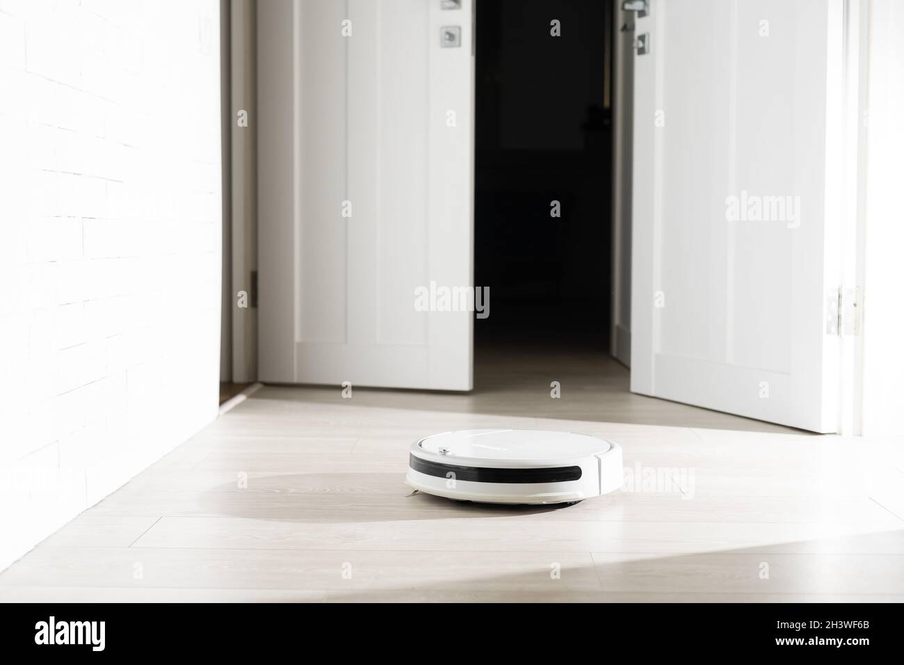 Robotic drone vacuum cleaner on laminate wood floor smart cleaning ...