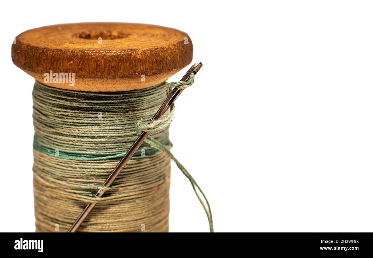 Vintage retro spool of thread on a white background. Needle with thread ...