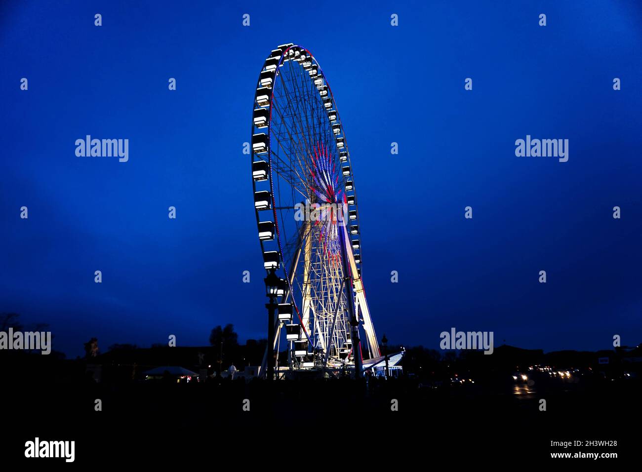 The attraction from an amusement park, a huge colorful wheel spinning ...