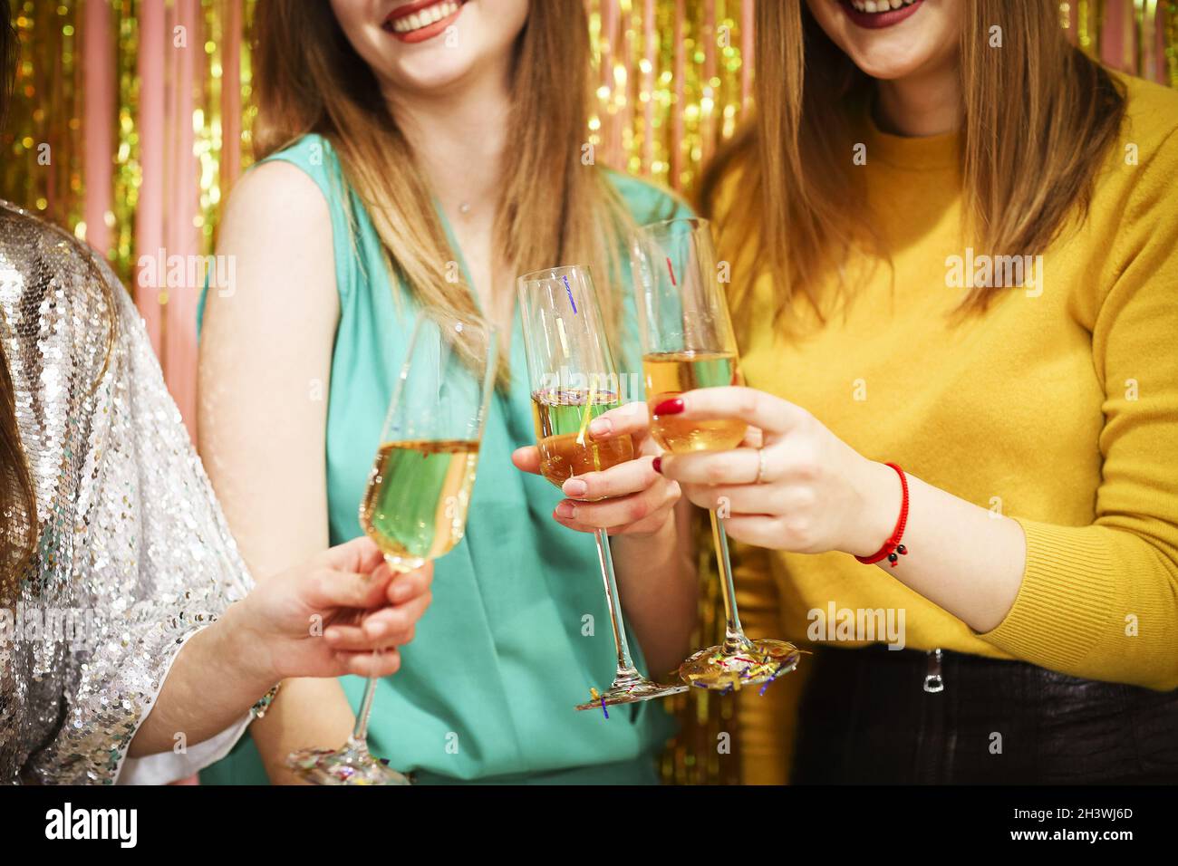 Crop women proposing toast during party Stock Photo - Alamy