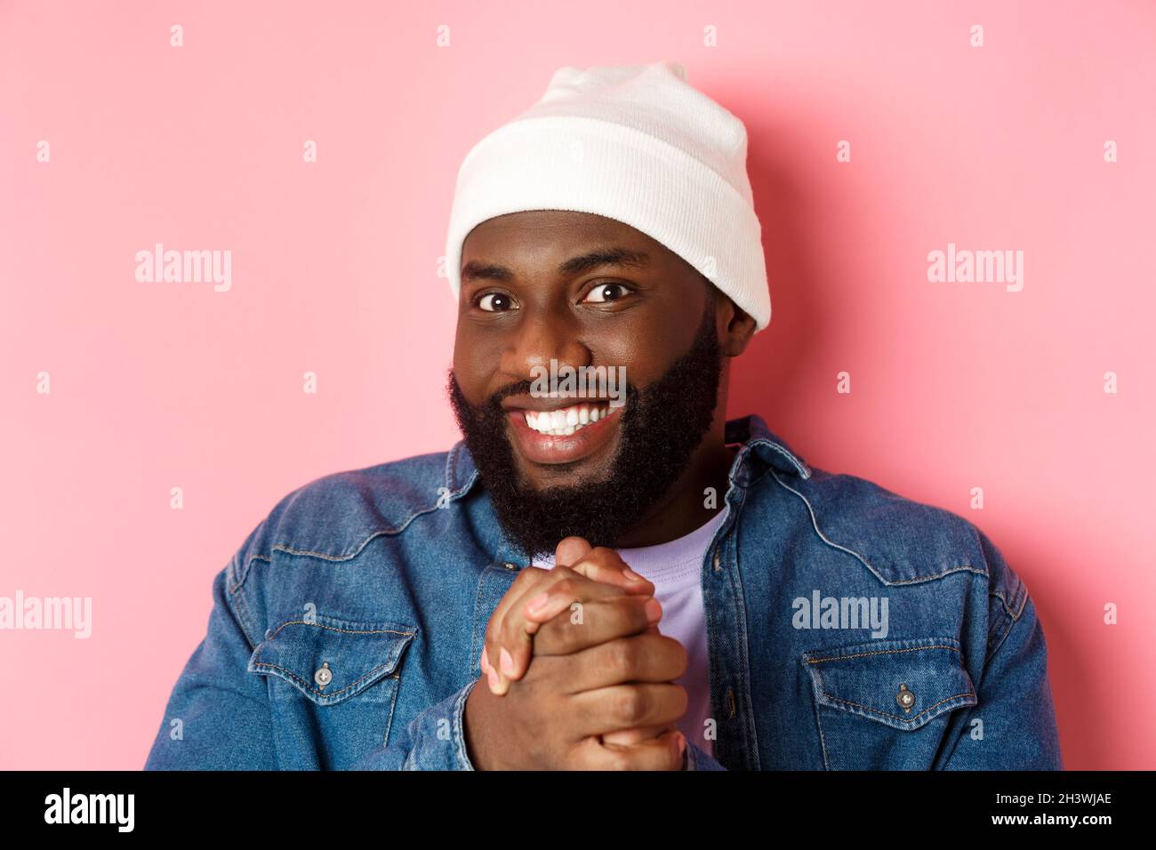 Close-up of devious and happy african-american man smiling satisfied ...